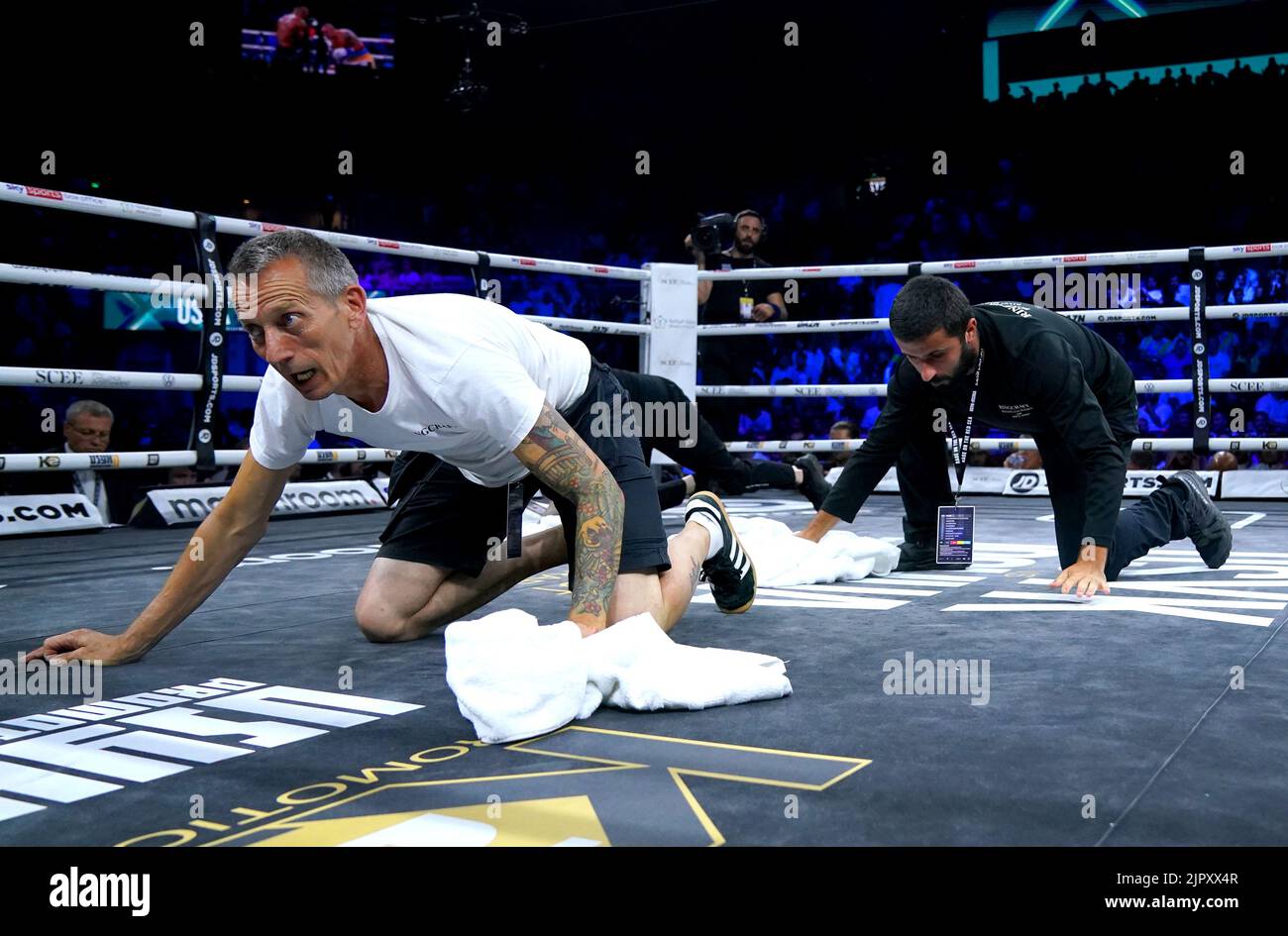 Staff dry the floor during the World Heavyweight Championship WBA Super ...