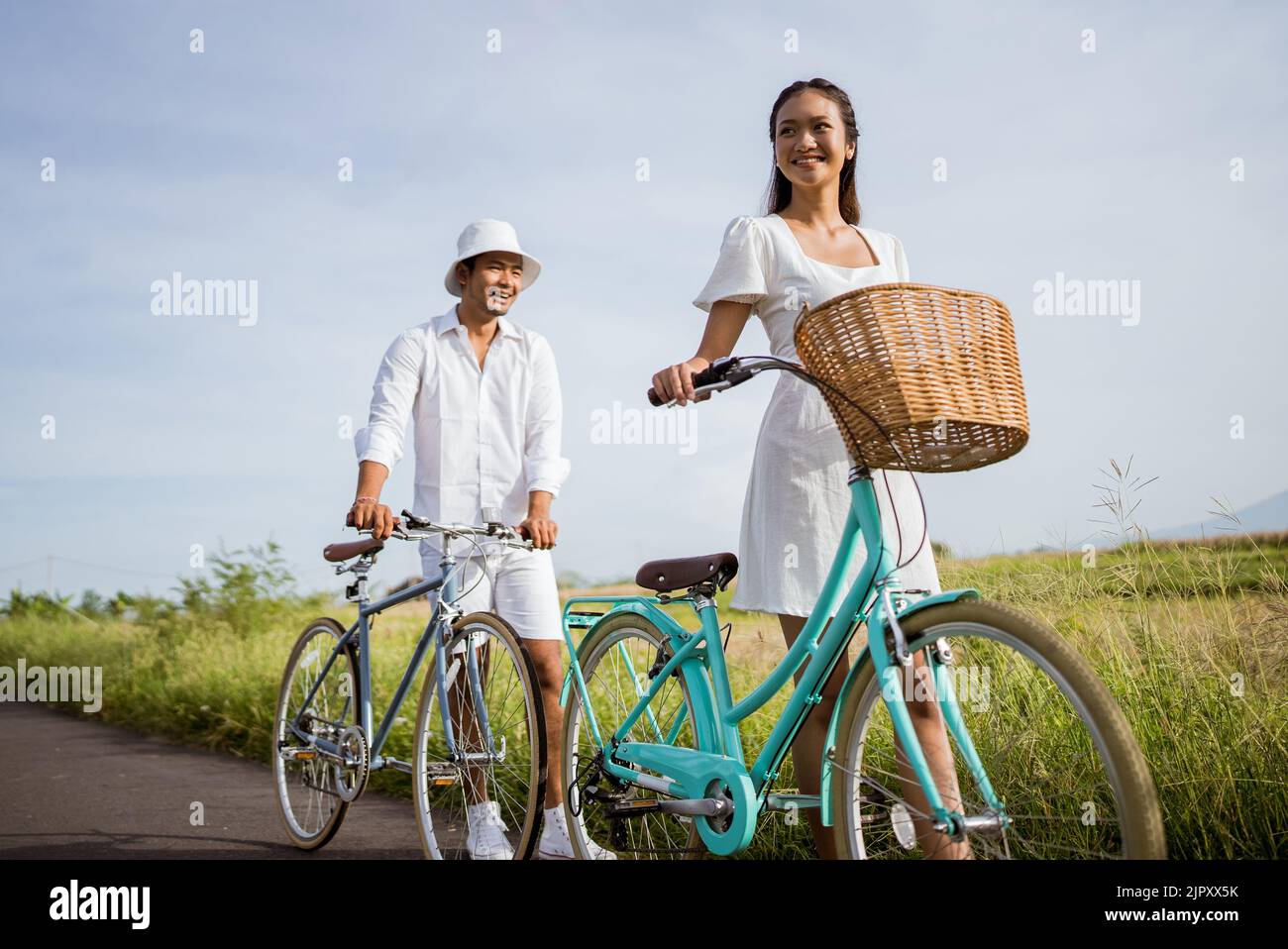 romantic couple push their bike as they are walking on the road Stock ...