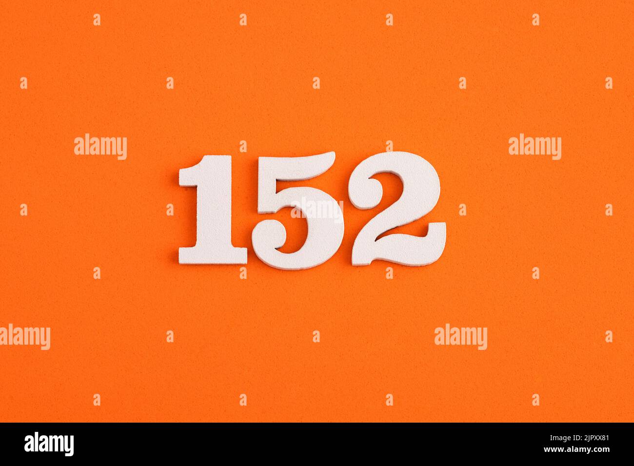 White wooden number 152 on eva rubber orange background Stock Photo - Alamy