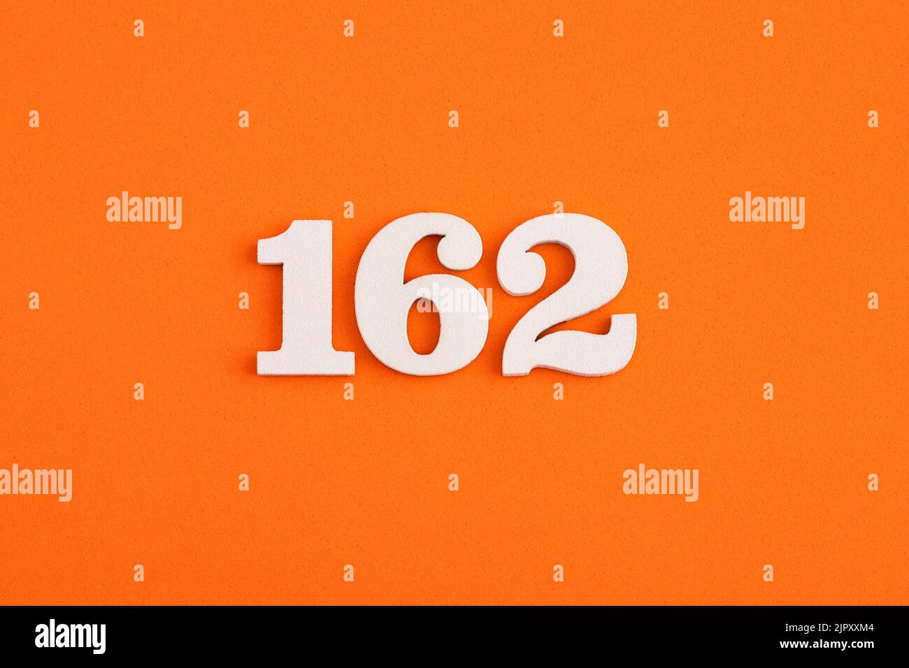 White wooden number 162 on eva rubber orange background Stock Photo - Alamy