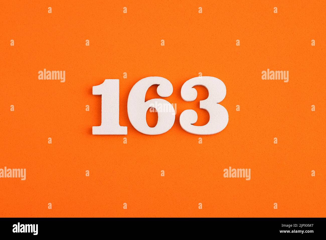 Number 163 - On orange foam rubber background Stock Photo - Alamy
