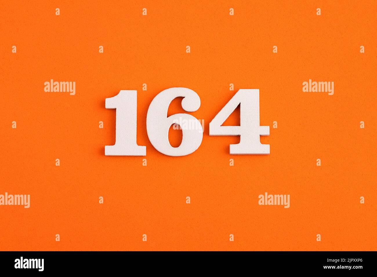 White wooden number 164 on eva rubber orange background Stock Photo - Alamy