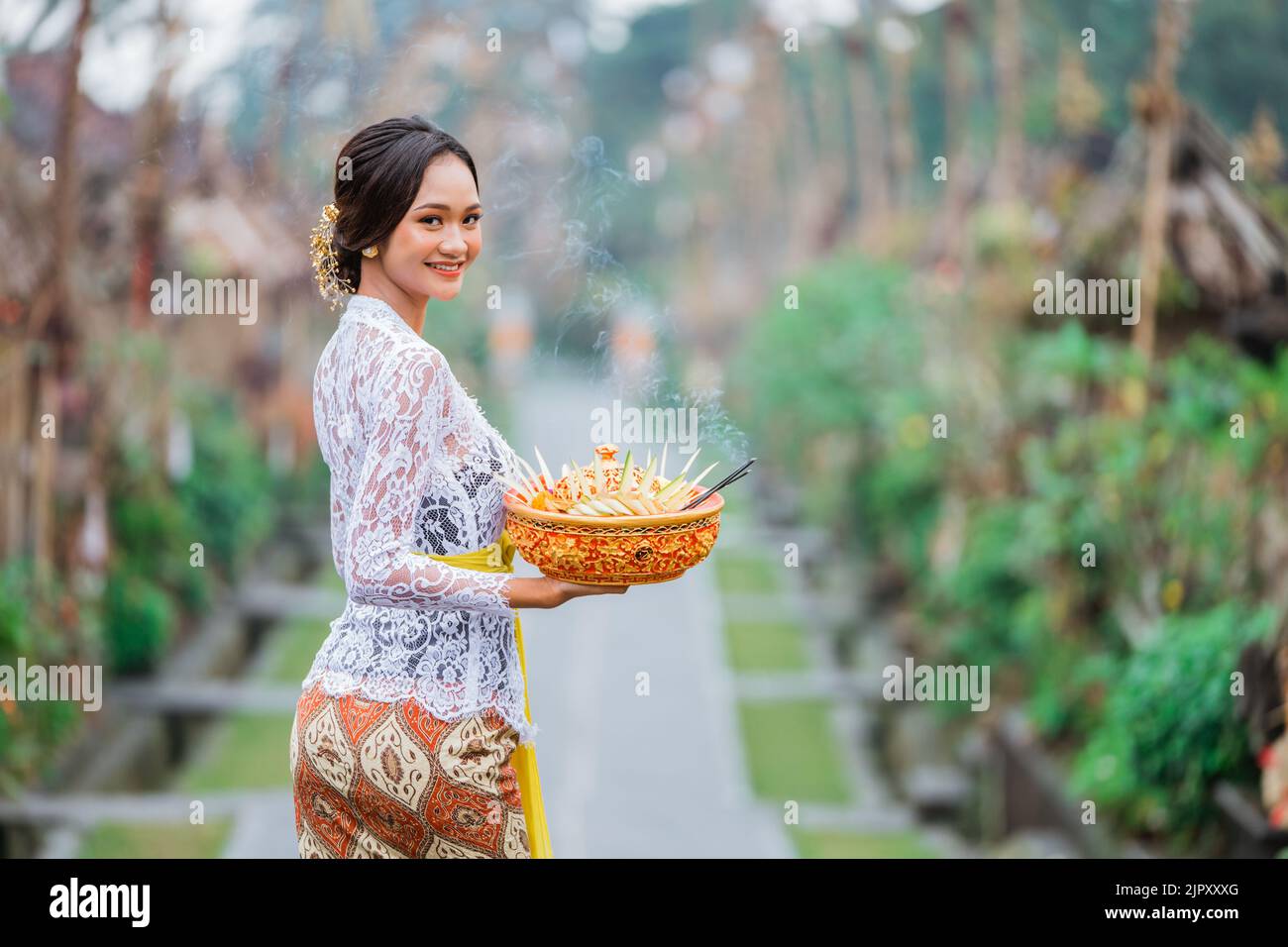 beauty of balinese woman smiling to camera standing in bali village ...