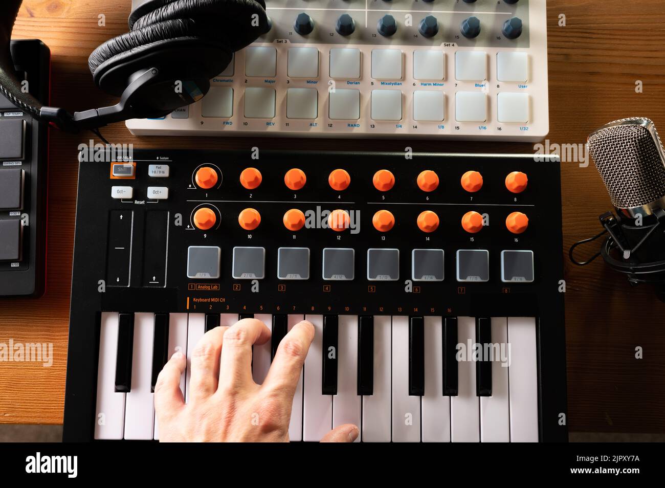 Close-up. Studio equipment. Modern midi keyboard and studio headphones ...