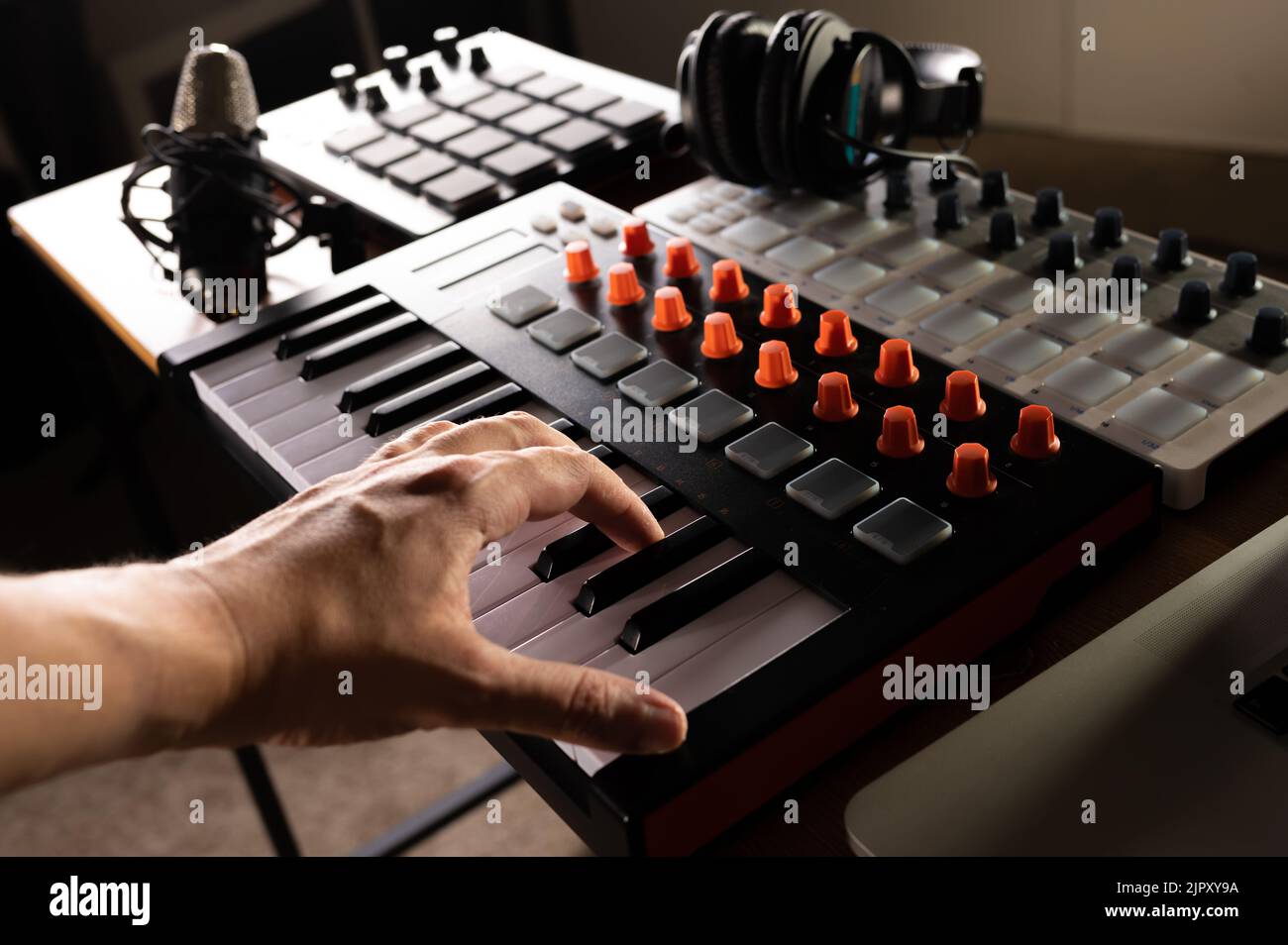 Recording studio, work with sound. Man's hand on the keys of a midi ...