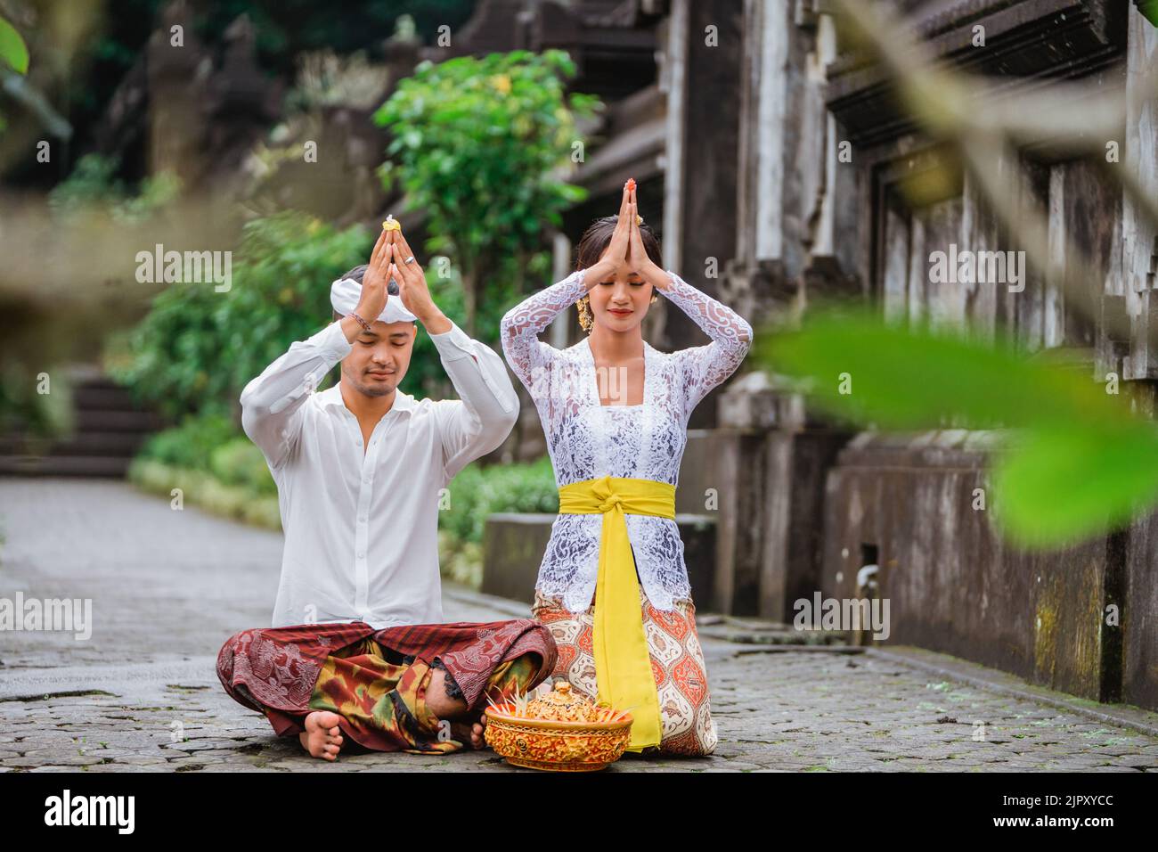 hindu make an offering to their god in bali Stock Photo - Alamy