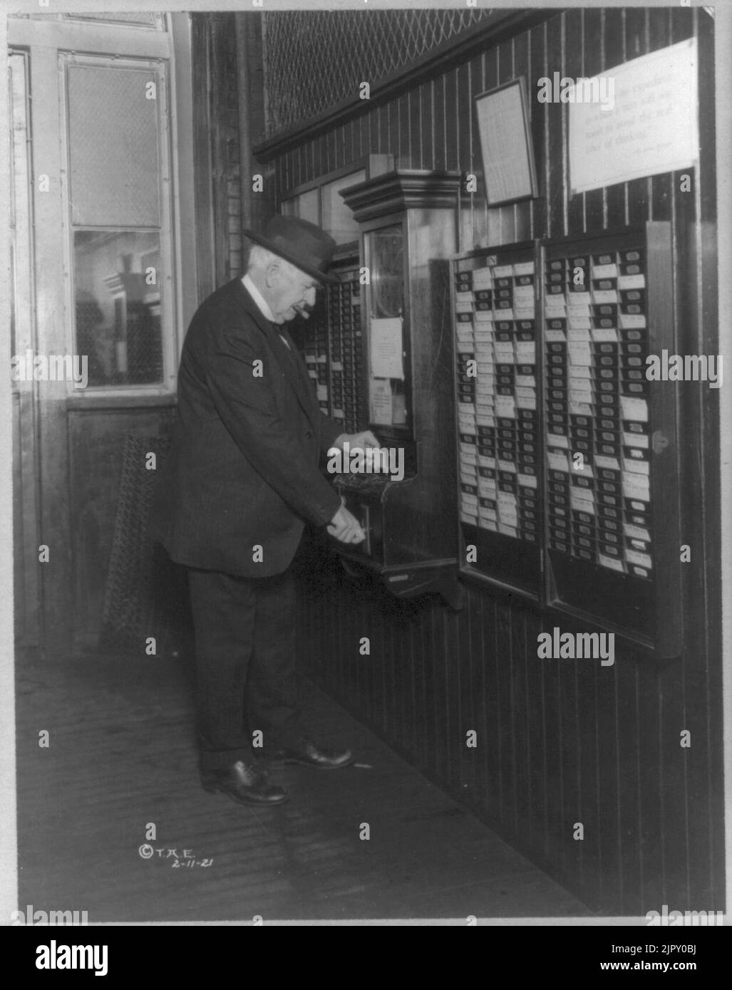 Thomas Alva Edison, 1847-1931, punching time clock on his 74th birthday ...