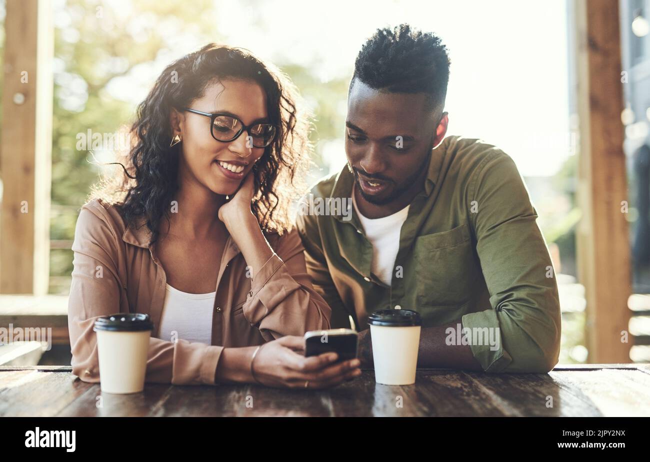 Another way technology connects people. a young couple using a mobile ...