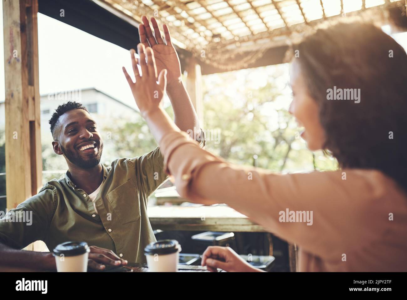 High five to making new connections. a young couple giving each other a ...