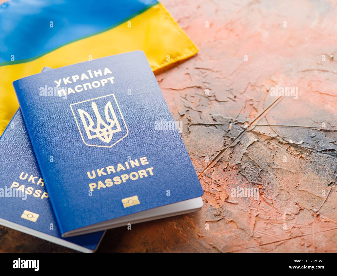 On an orange background, the state Ukrainian flag and two Ukrainian ...