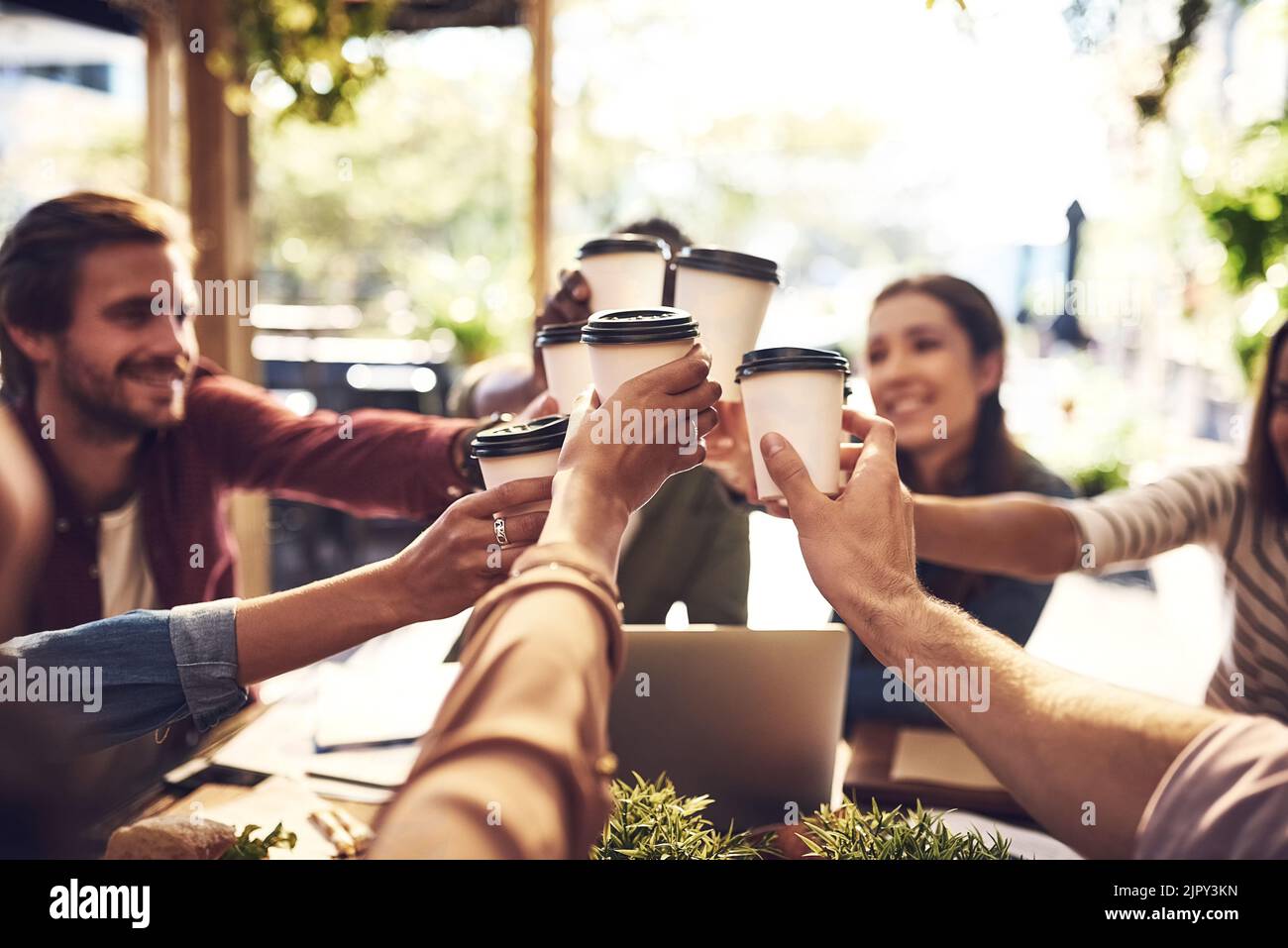 Toast to a successful meeting. creative employees toasting with coffee ...