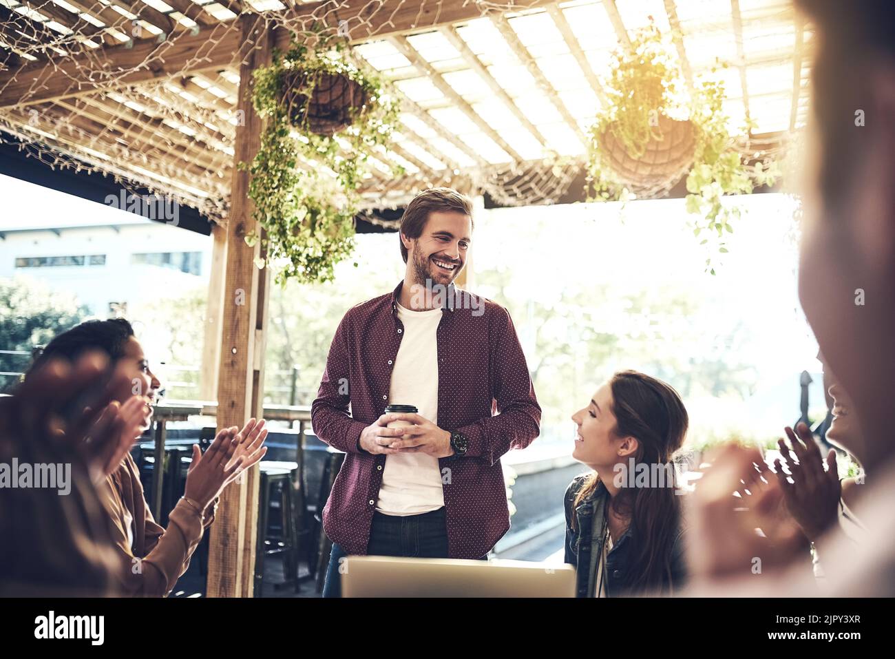 Applauding his innovative ideas. creative employees having a breakfast ...