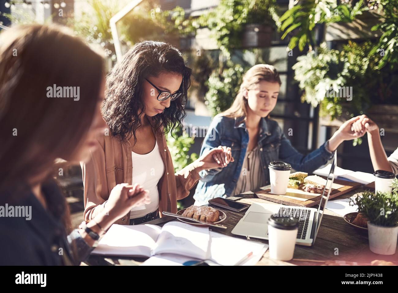 Prayer is good for the team. creative employees holding hands and ...