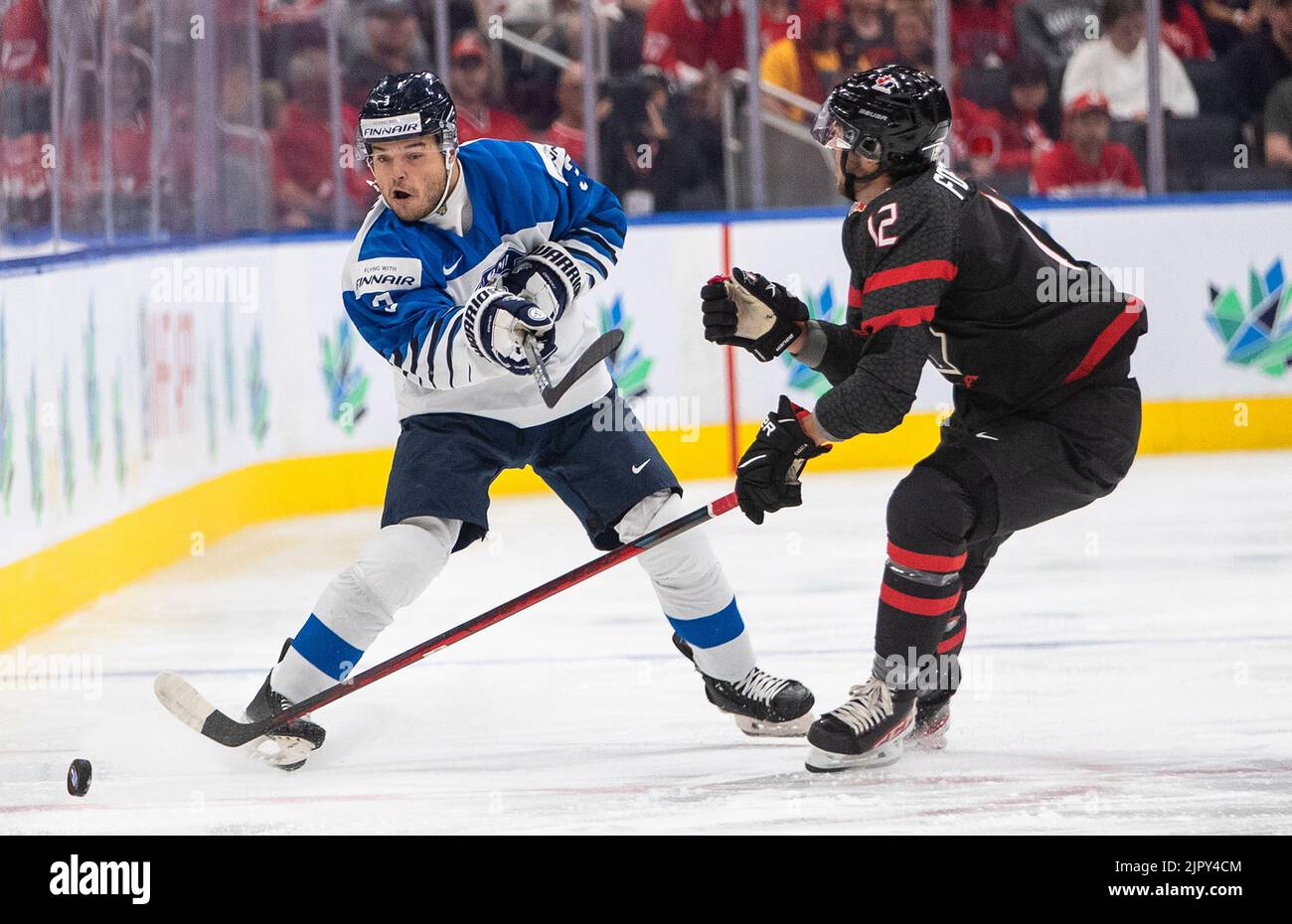 Canada's Tyson Foerster (12) and Finland's Ruben Rafkin (3) battle for ...
