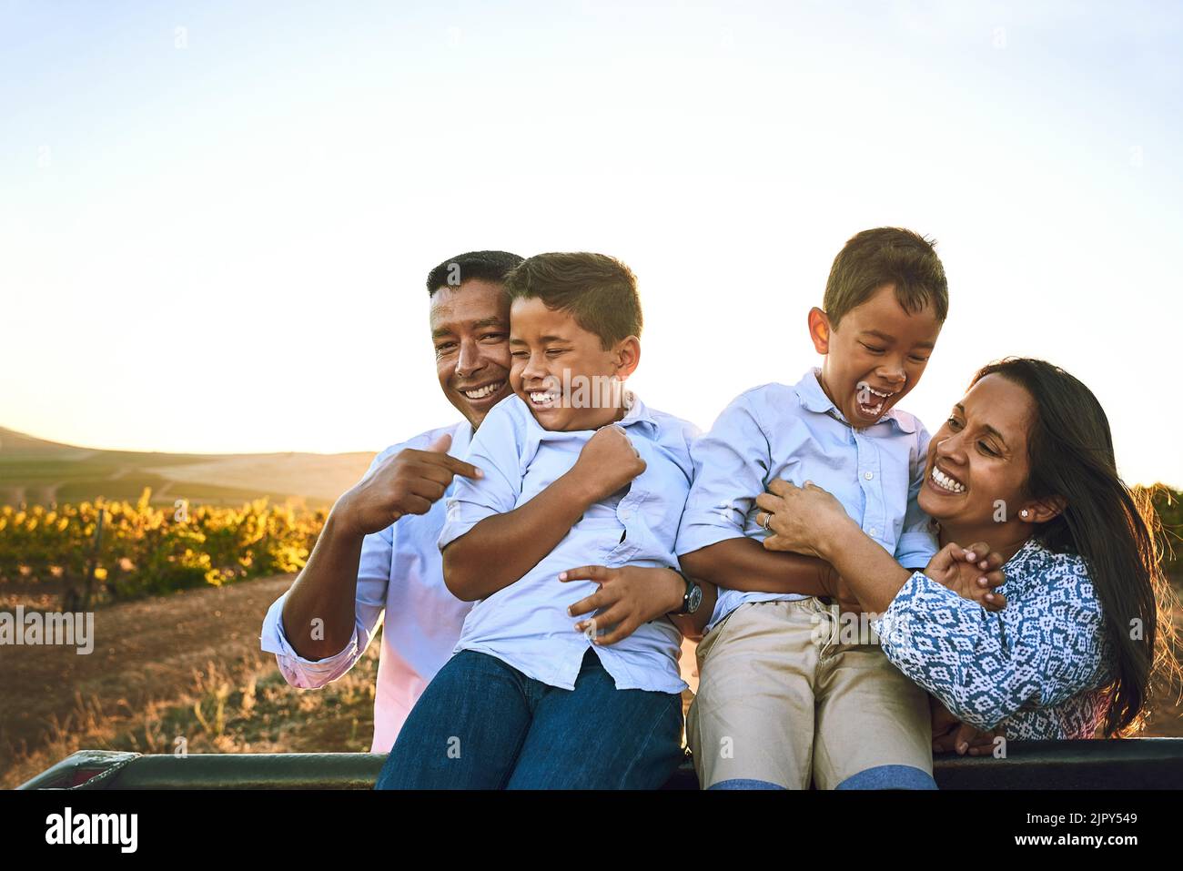 Love and laughter are always in their family. a happy family bonding together outdoors Stock ...