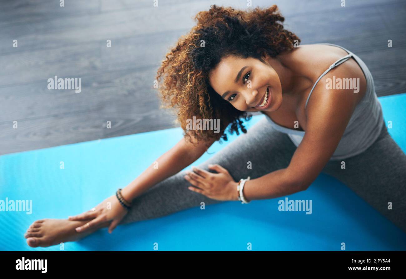 Stretch and watch how you will stress less. High angle shot of a young ...