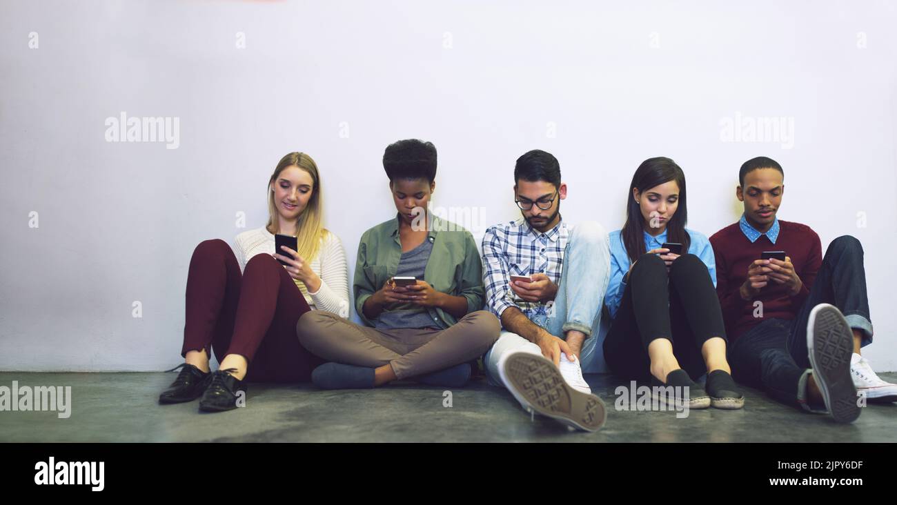 Chilling between classes. Full length shot of a group of university ...