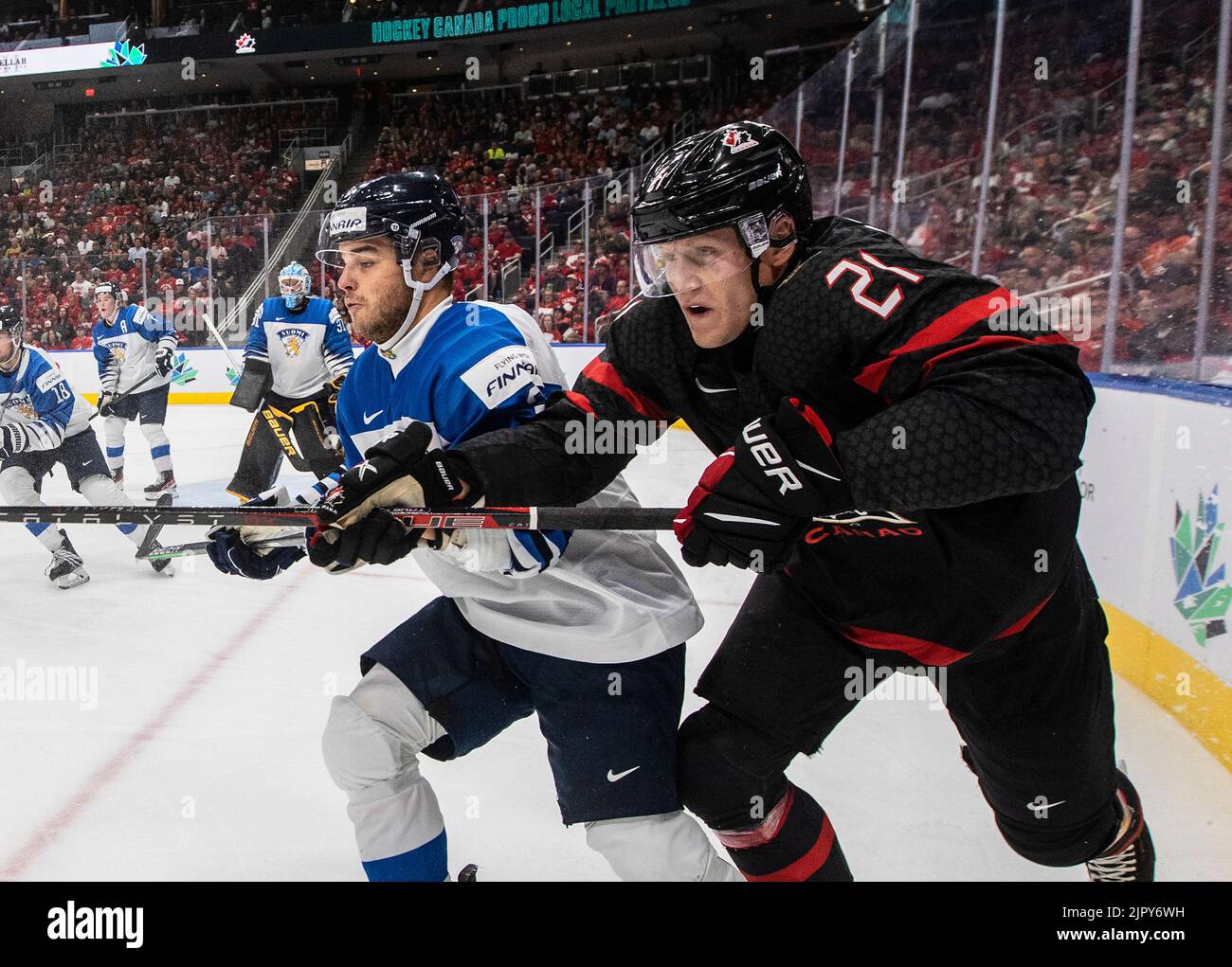 Canada's Nathan Gaucher (21) battles on the corner with Finland's Ruben ...