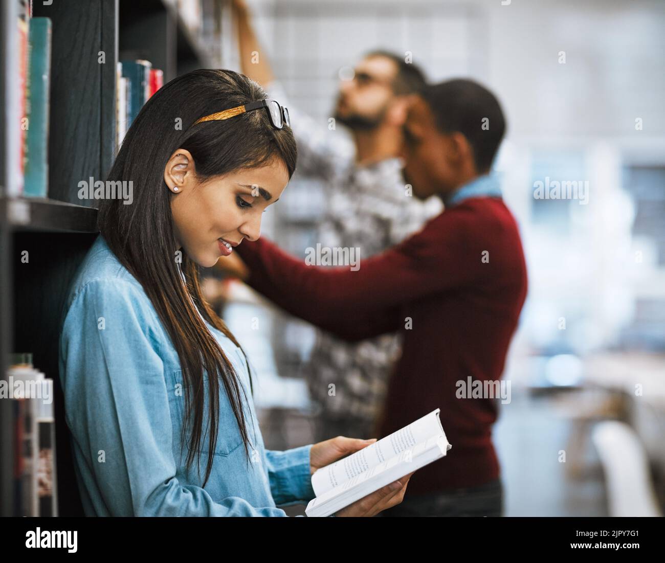 What a interesting novel. a group young students standing in a library ...