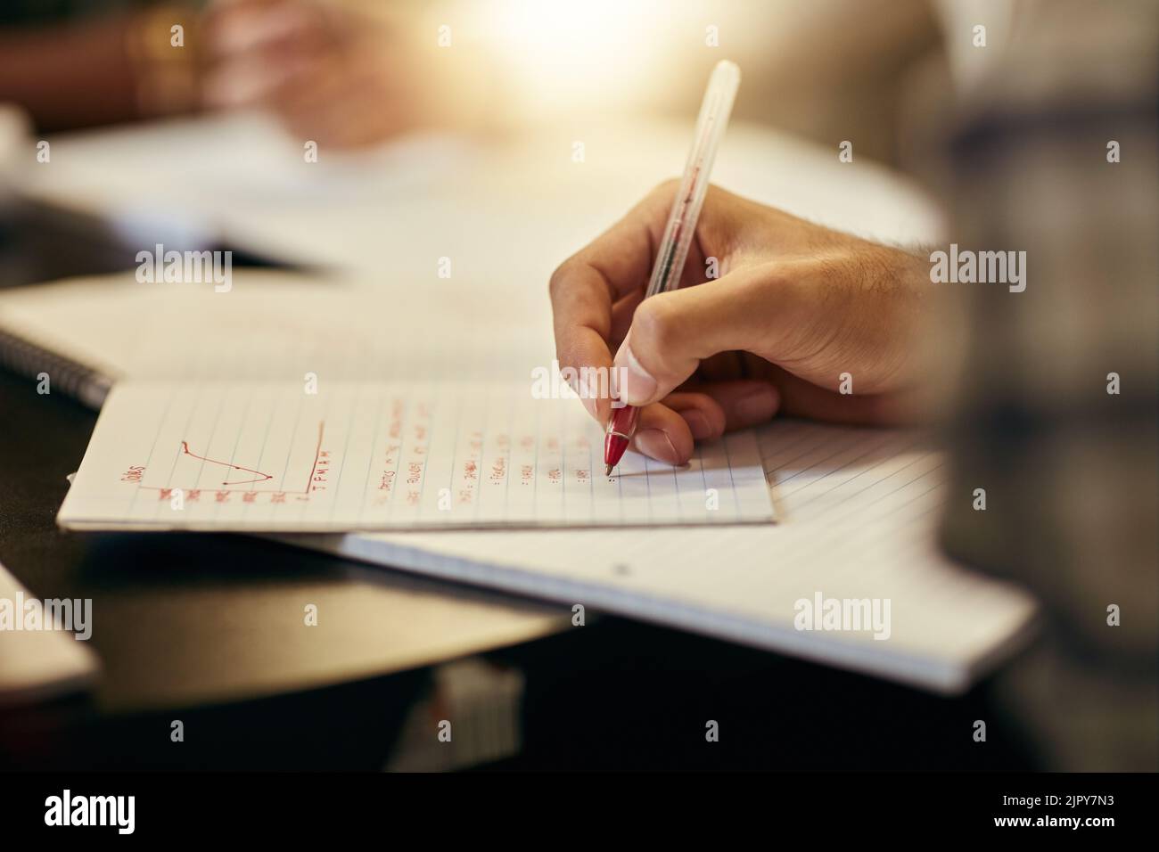 Going through the last points. a unrecognizable student writing down ...