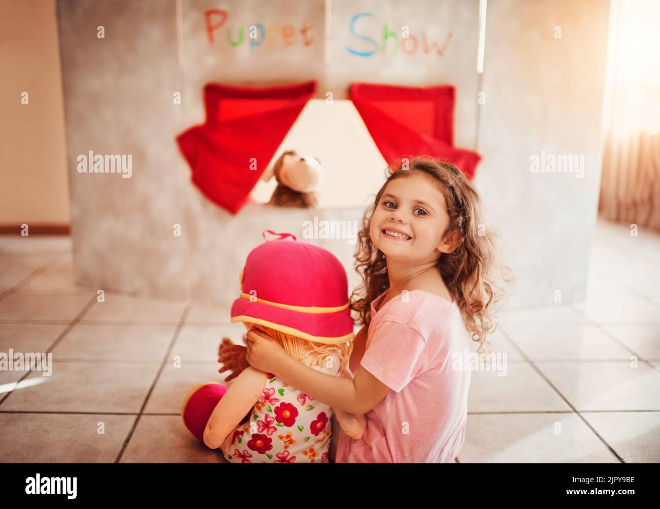 The puppet show is about to start. Portrait of a n adorable little girl ...