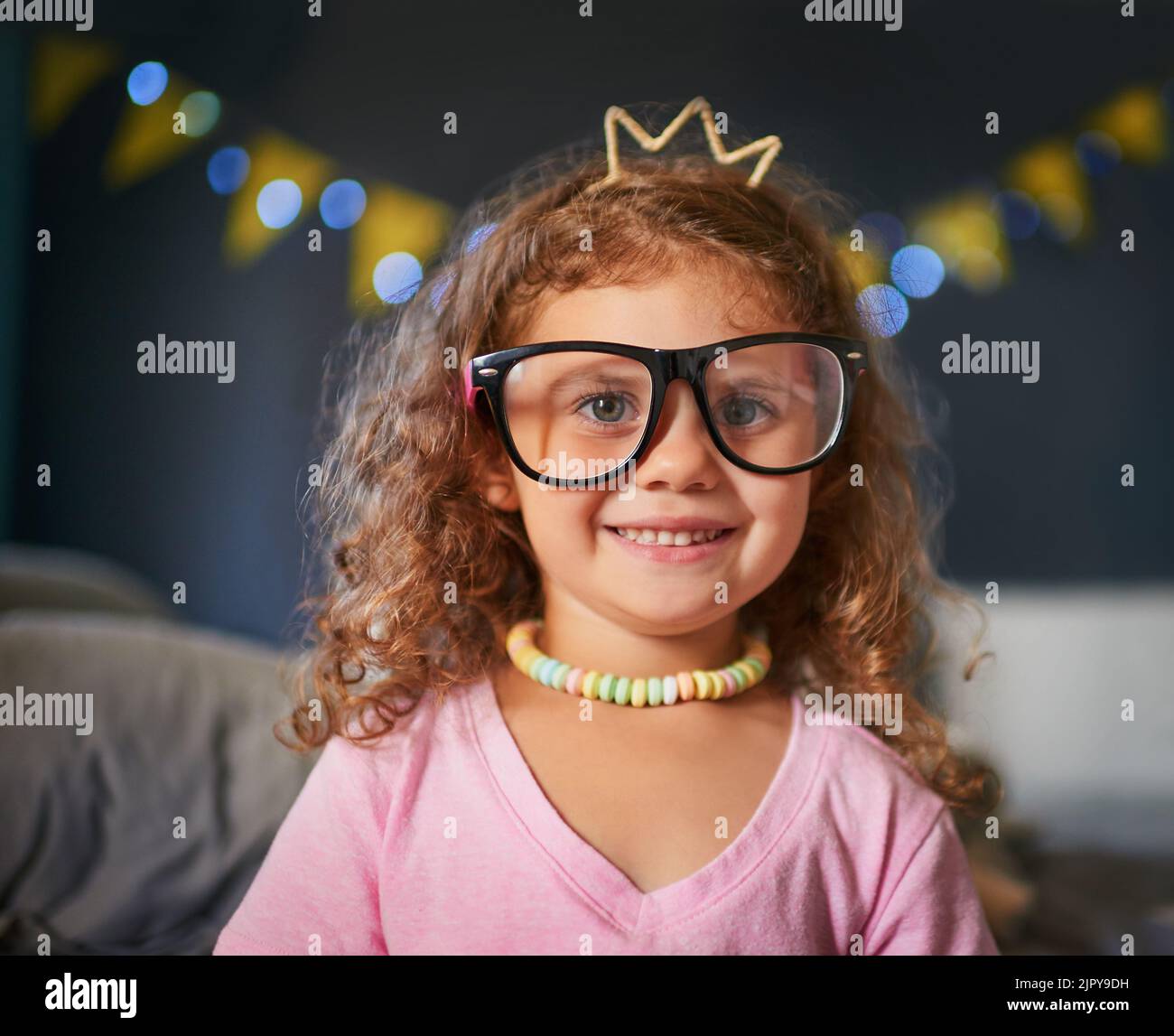Shes a cutie. Portrait of an adorable little girl playing dress-up at ...