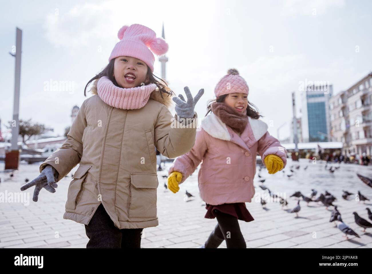 two little girl playing chasing a bird in istanbul taksim Stock Photo ...