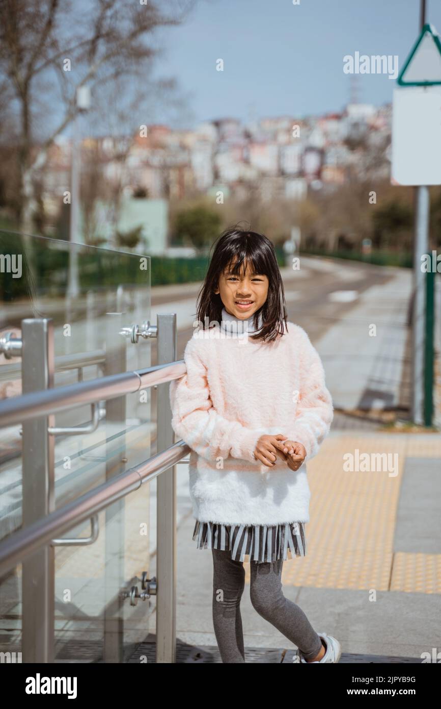 asian little girl smiling to camera standing outdoor Stock Photo - Alamy
