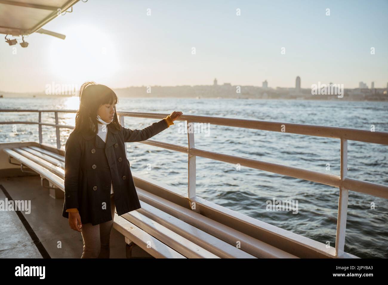 girl in ferry boat leaning against the railing Stock Photo - Alamy