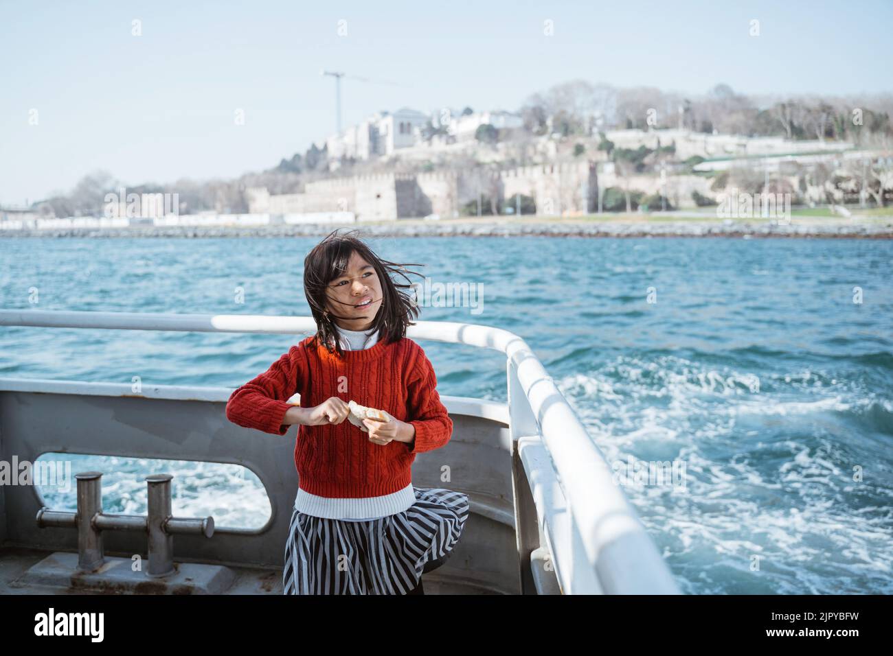 girl in ferry boat leaning against the railing Stock Photo - Alamy