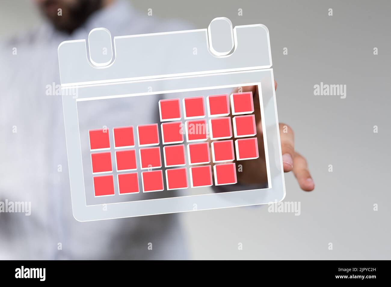 A man's hand touching a floating 3D calendar Stock Photo - Alamy