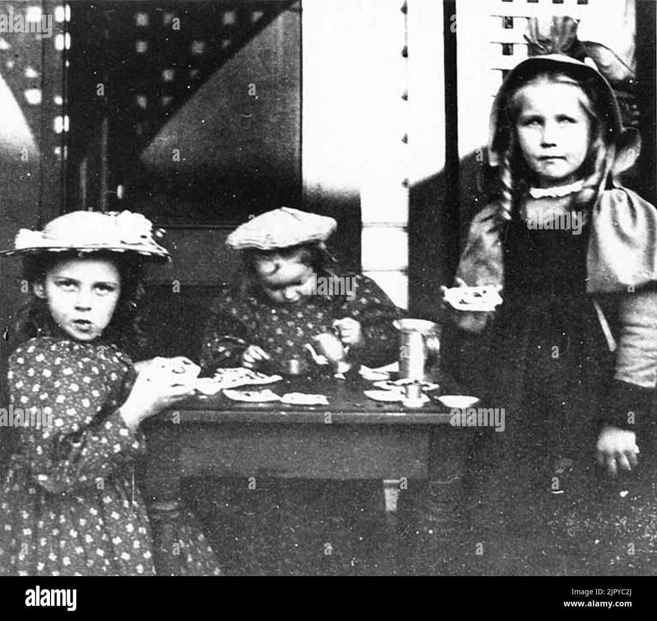 Three girls having tea party at Grace McMonagle's house, probabaly ...