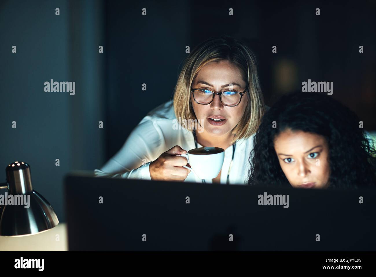 Teamwork will take them through the night. two colleagues using a ...