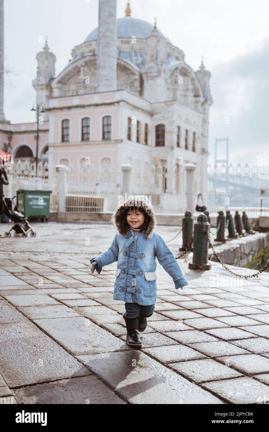 kid running around the square in turkey with ortakoy mosque Stock Photo ...