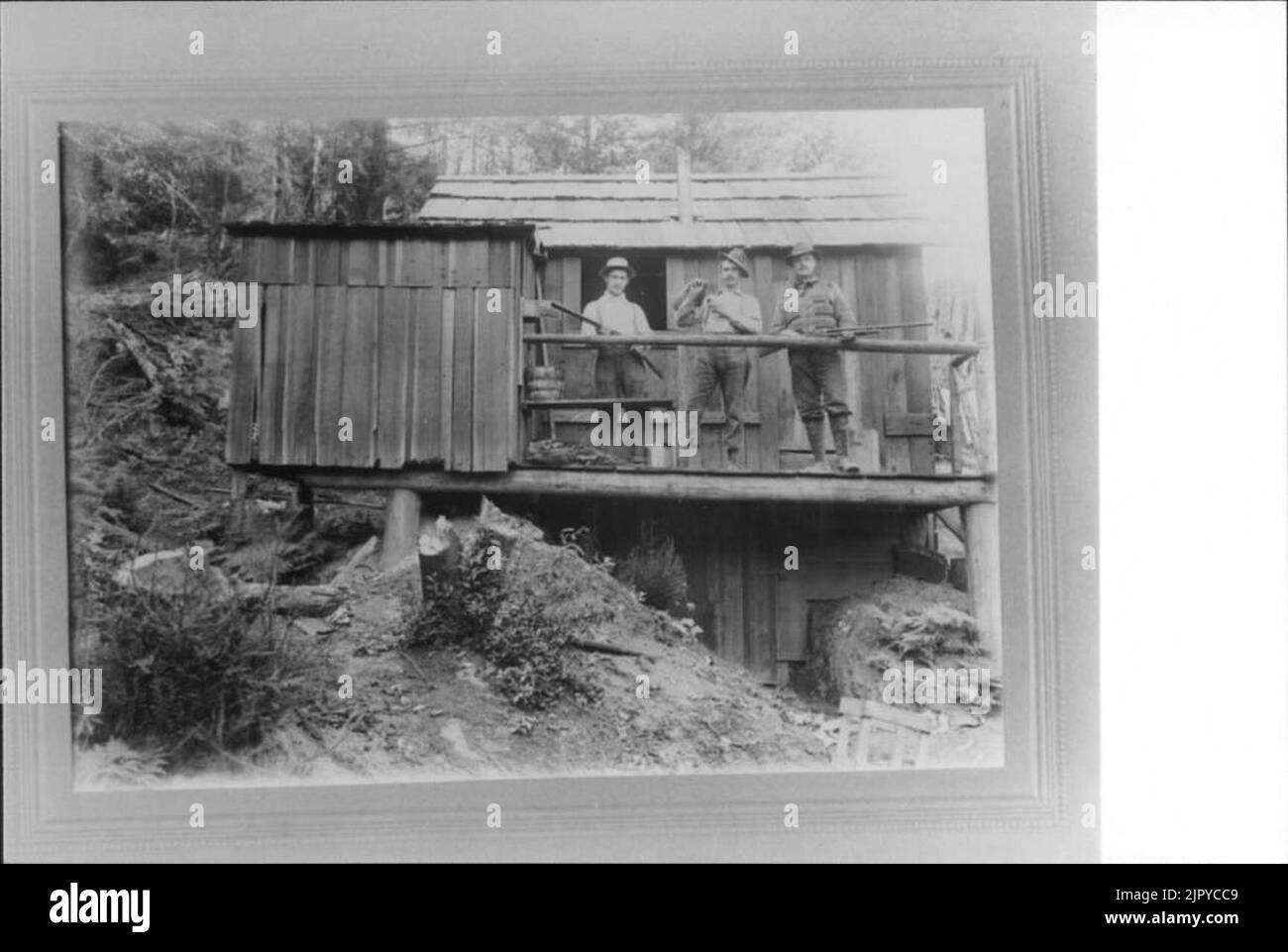 Three men at a logging camp Stock Photo - Alamy