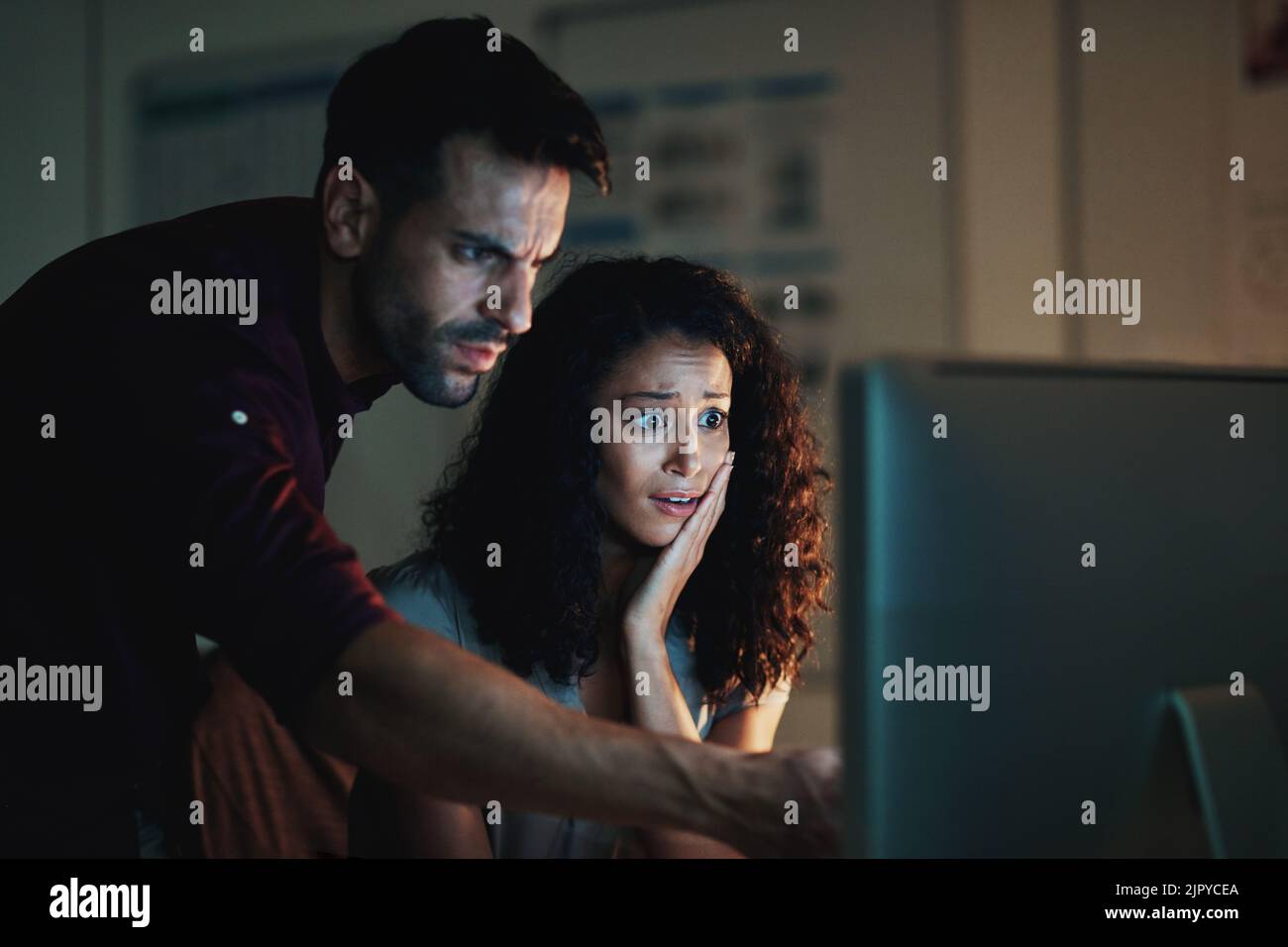 Please tell me you can fix this. two colleagues using a computer ...