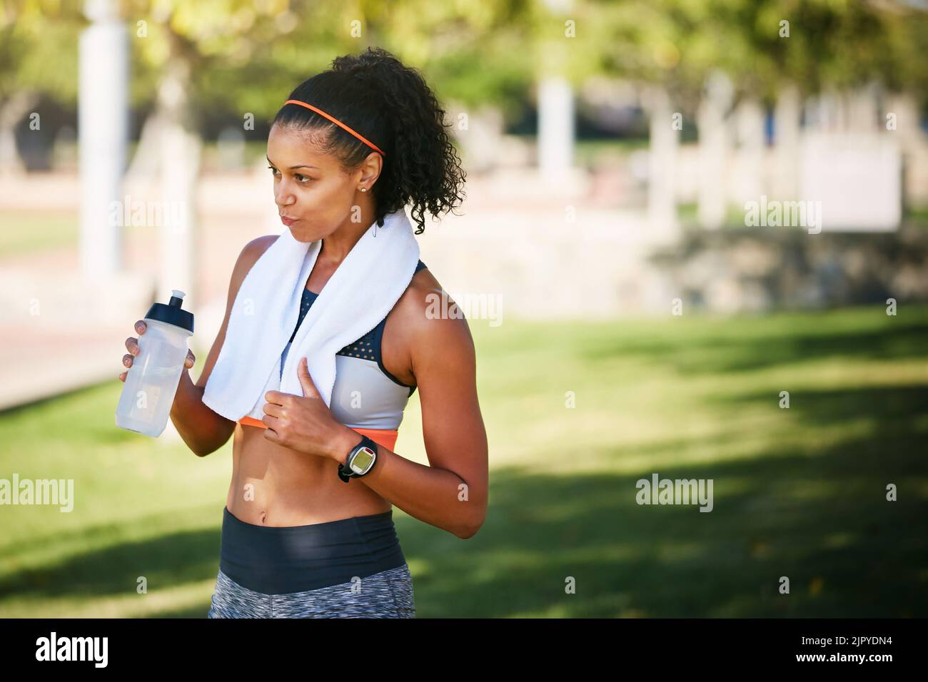 Staying hydrated after working up a sweat. a sporty young woman ...