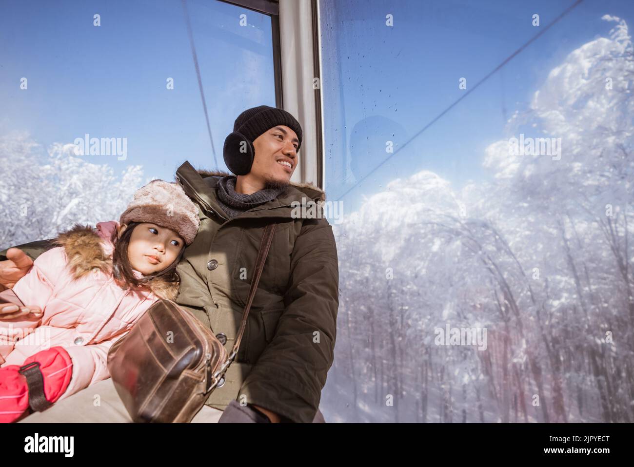 potrait of a man and kid riding a cable car Stock Photo - Alamy
