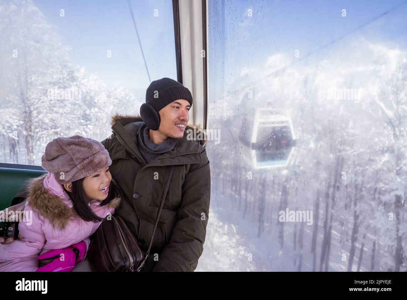 potrait of a man and kid riding a cable car Stock Photo - Alamy
