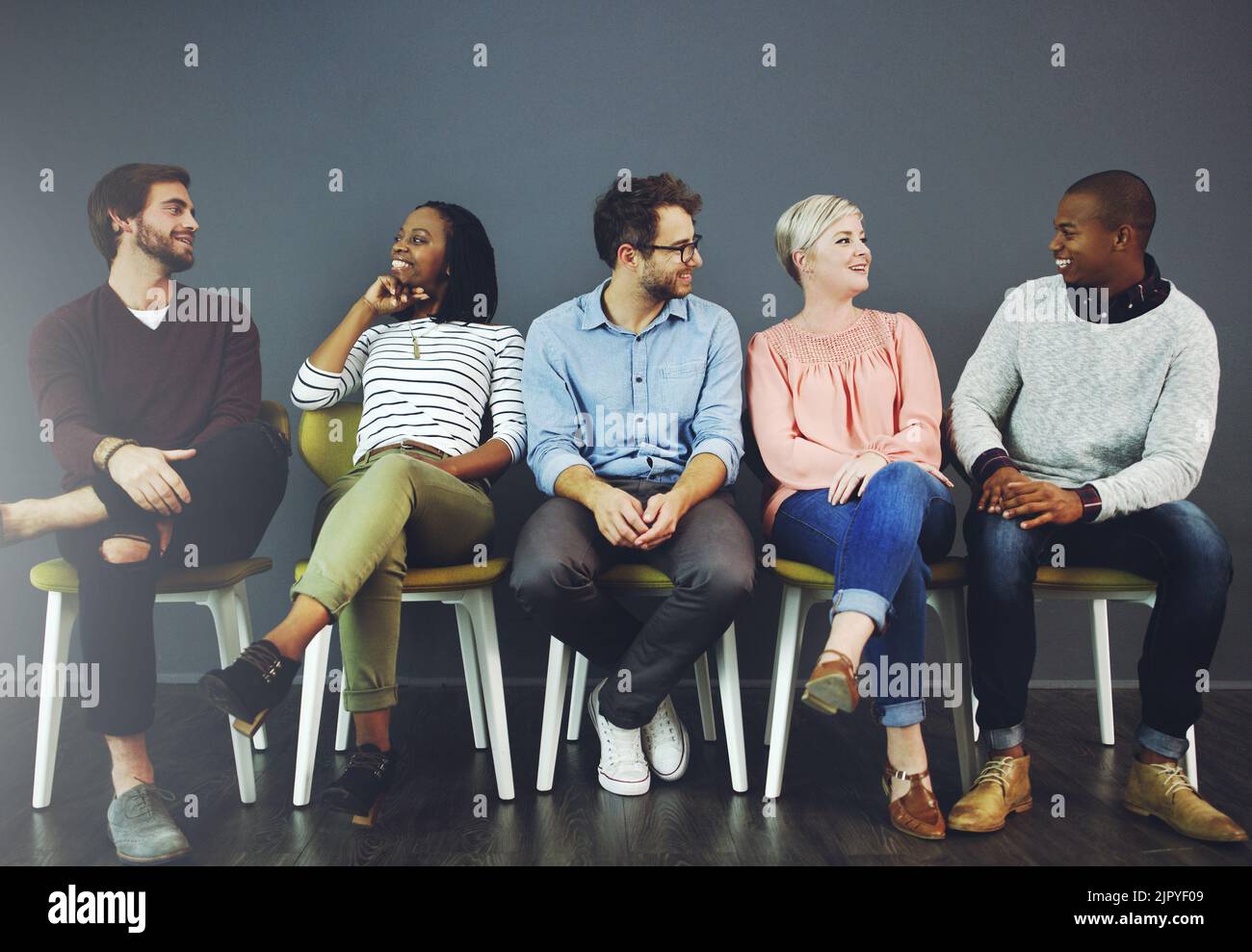 Passing the time with some friendly conversation. Studio shot of a ...