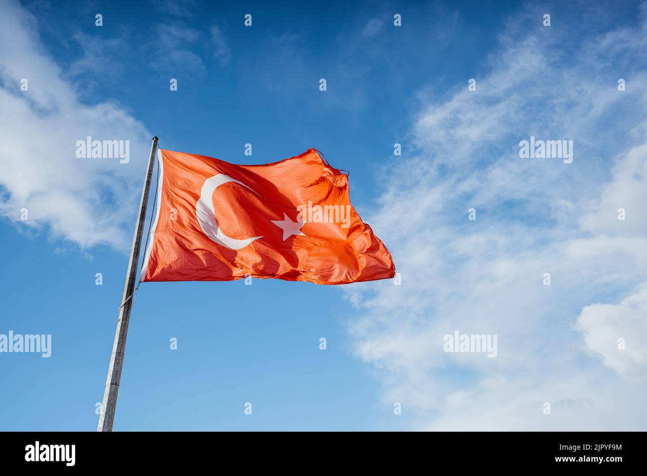 turkey flag under the blue sky waving Stock Photo - Alamy