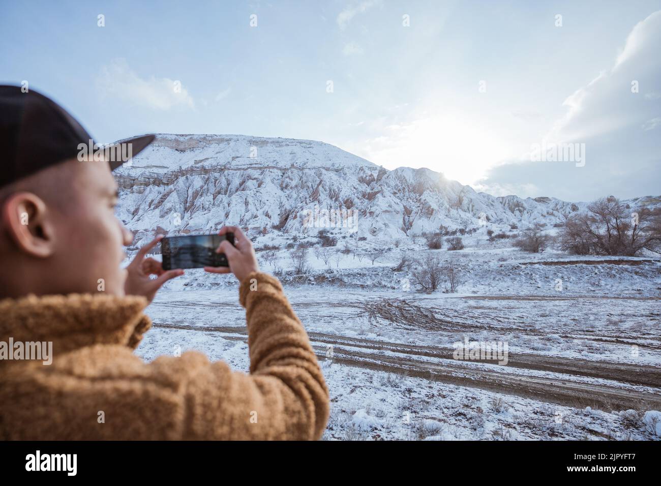 man taking picture of beautiful snowy scenery Stock Photo - Alamy