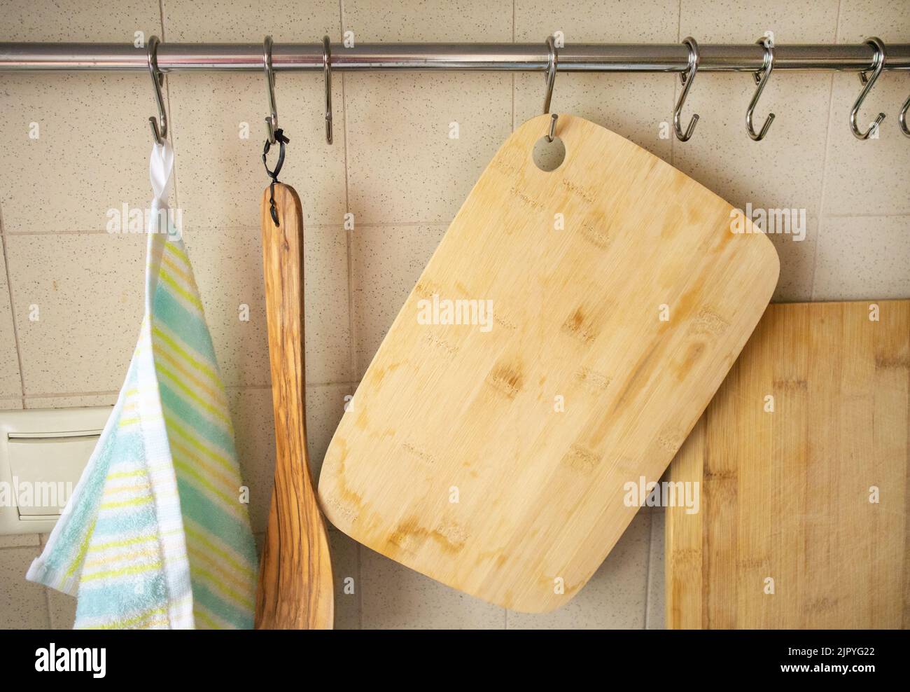 A close-up of cutting wooden boards, a cooking spatula, a kitchen towel ...