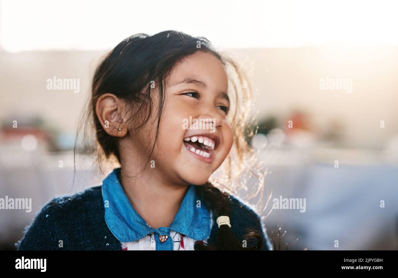 The smile of a child warms the heart. a cheerful little girl playing ...