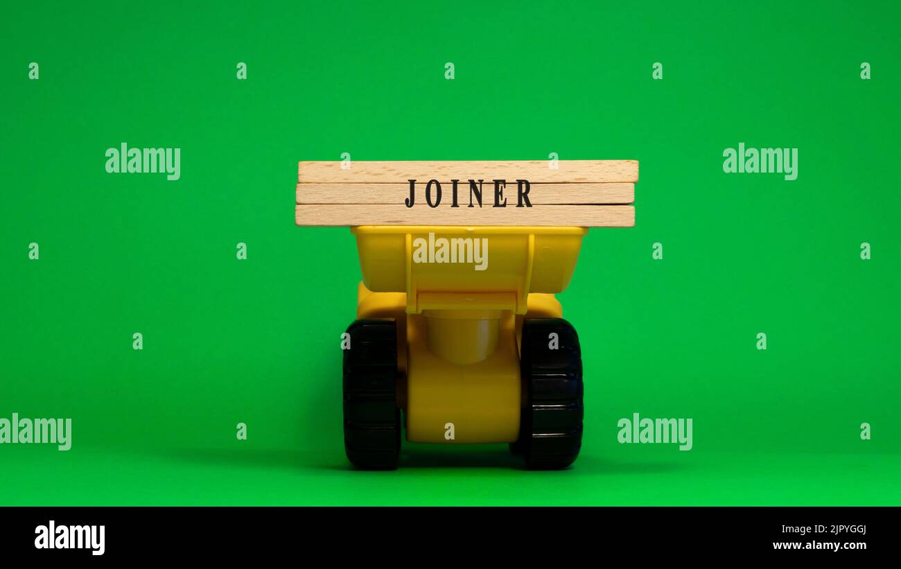 The word Joiner is written on wooden sticks. Machine concept. job ...