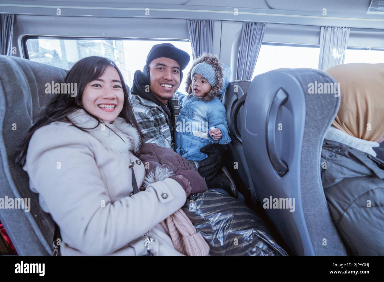 smiling parent and toddler sitting inside the bus Stock Photo - Alamy