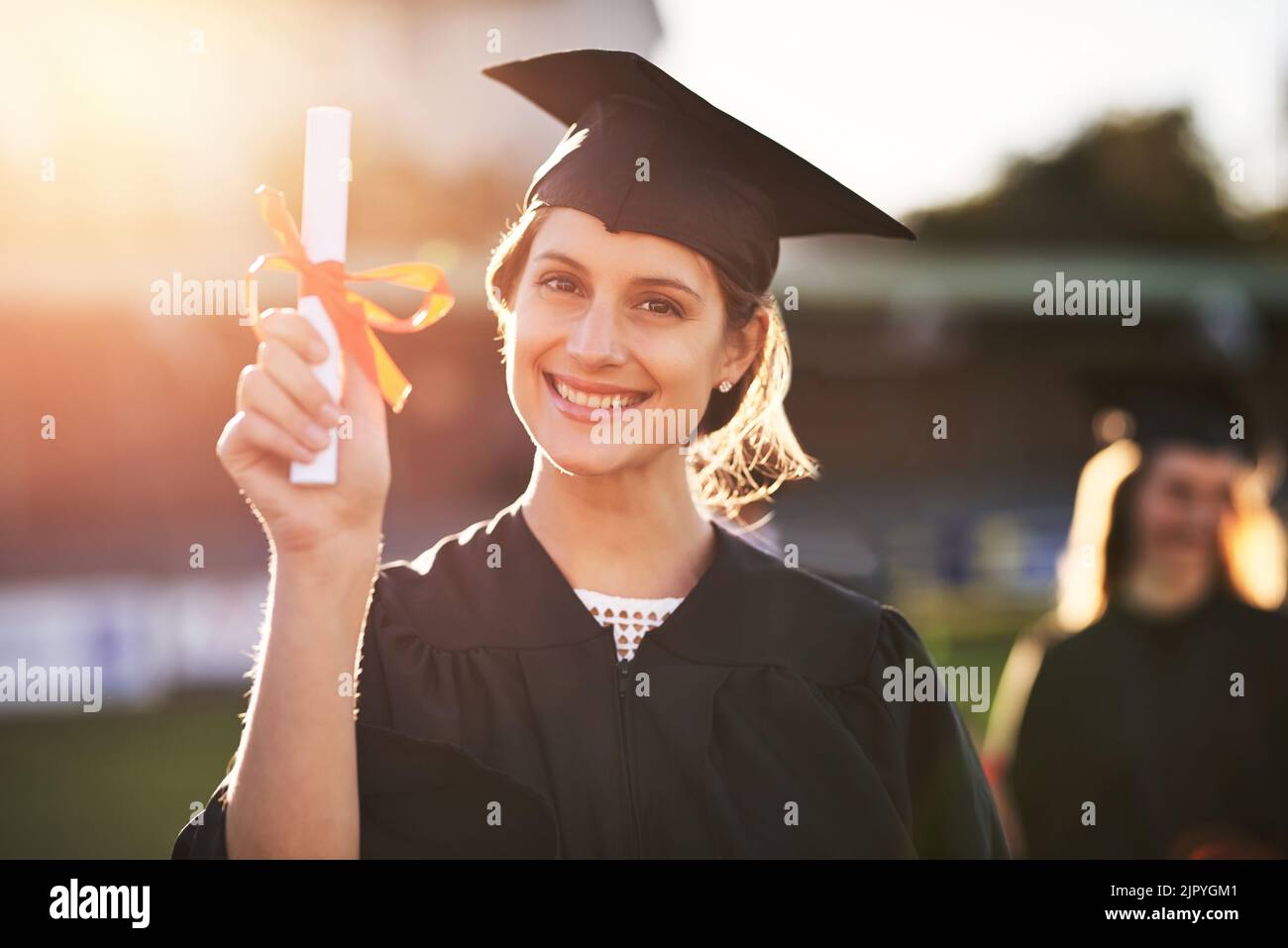 Degree in hand and ready to go. Portrait of a happy young woman holding ...