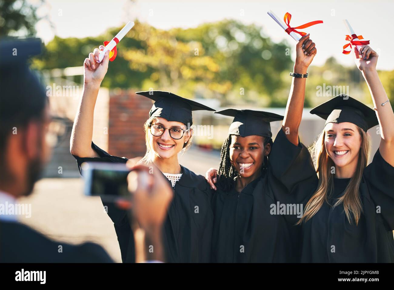 Graduation for the win. a group of students taking pictures with a ...