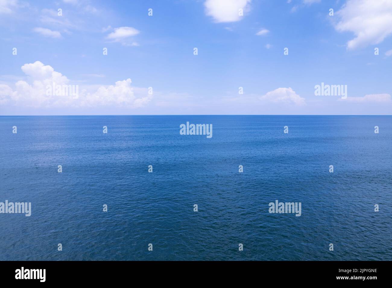 Aerial view of a blue sea surface water texture background and sun ...