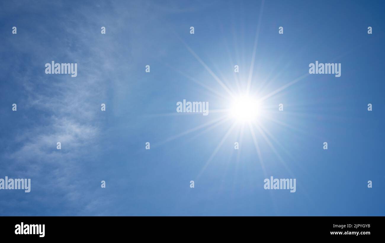 Shining sun on clear blue sky with lens flare of sunlight on sky ...